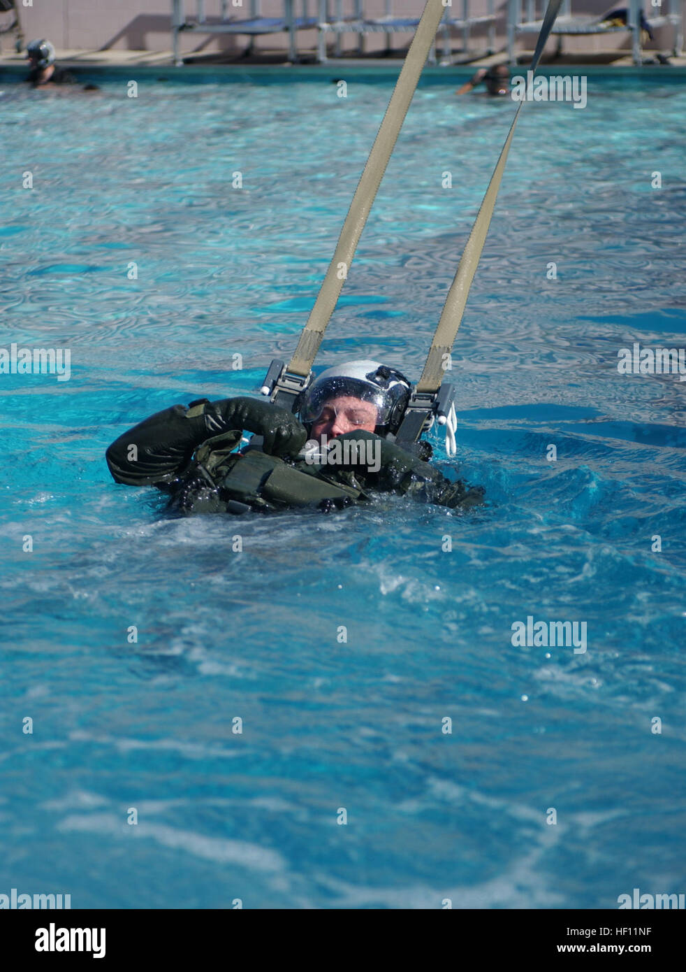 A Sailor is dragged through the water during an exercise simulating a ...