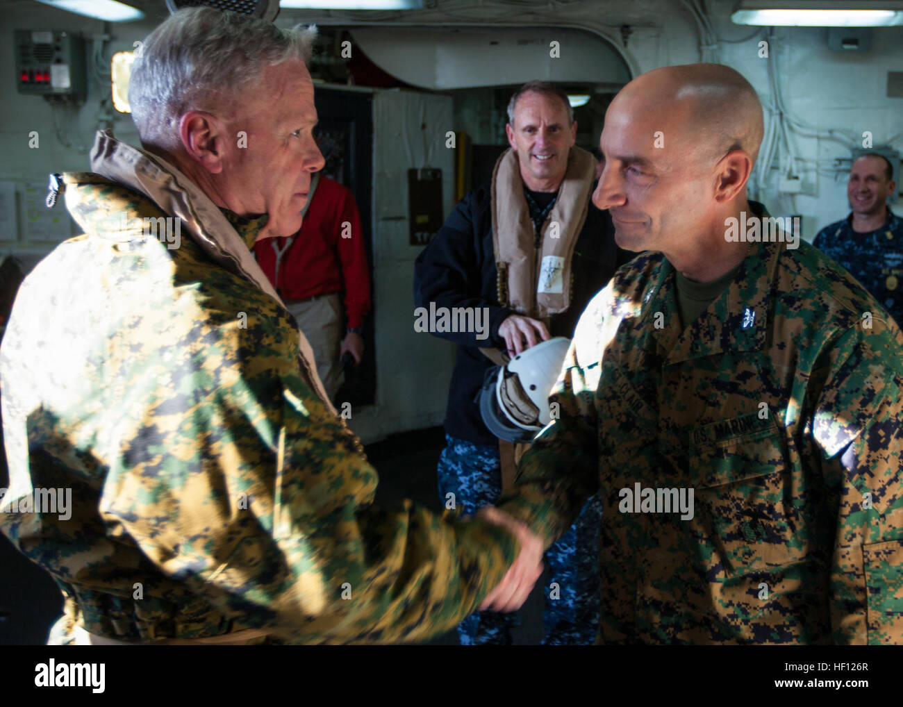 Gen. James F. Amos, commandant of the Marine Corps, shakes the hand of ...