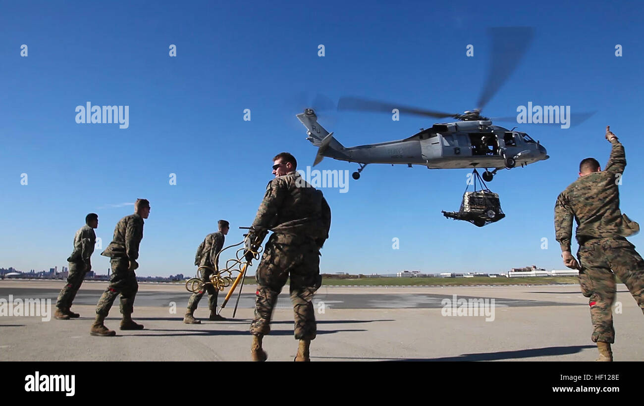 U.S. Navy MH-60S Seahawk transports a generator as Marines assigned to ...