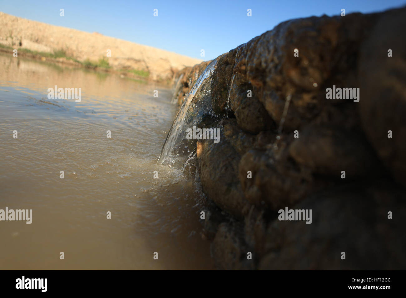 Diverted water spills into the causeway on the Helmand River in Sangin ...