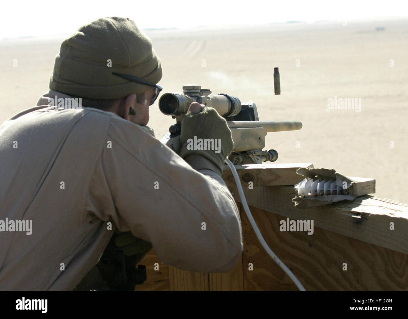 As a spent 7.62mm cartridge tumbles through the air, a sniper with the ...