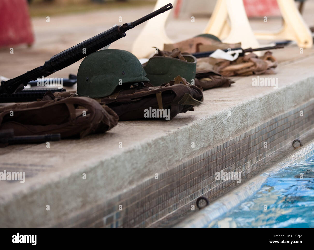 Combat gear lays at the side of a pool before being used during the ...