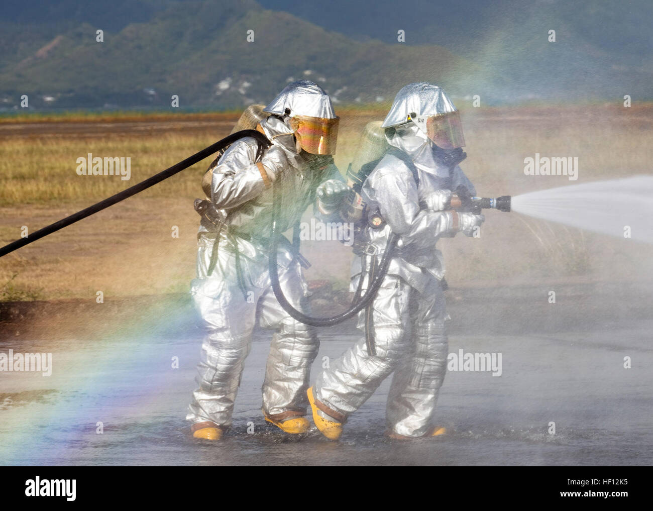 Crash Fire Rescue Marines work together to spray a mock helicopter ...