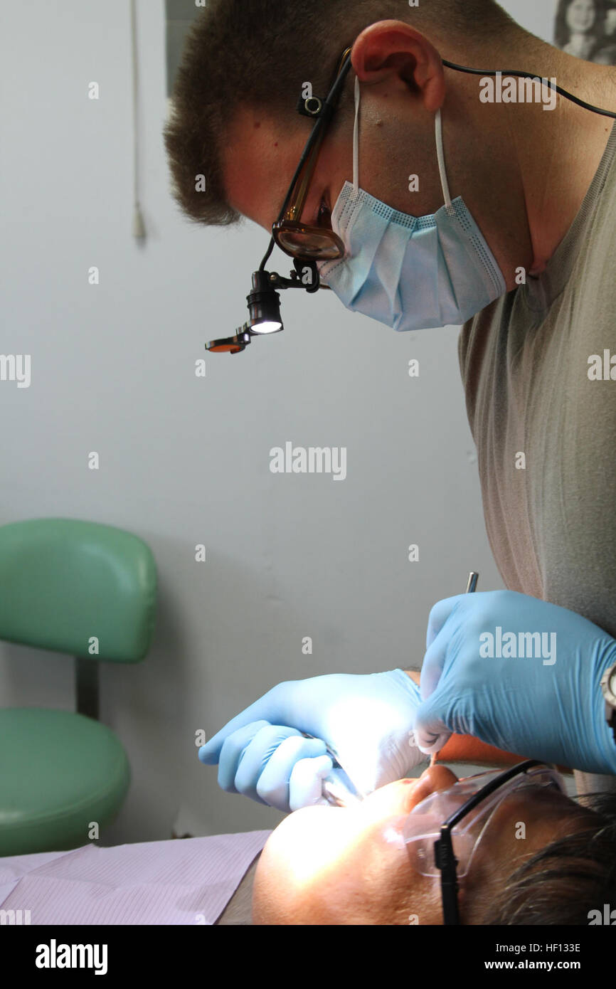 Lt. Cmdr. Michael Flannery works on a patient at the Tinian Health ...