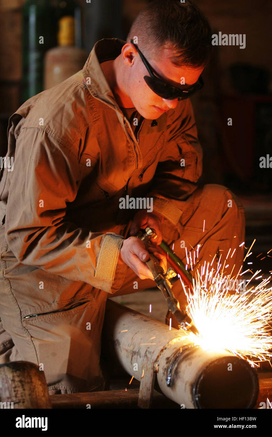 060112-M-1226J-003 A U.S. Marine Corps engineer uses a cutting torch to ...
