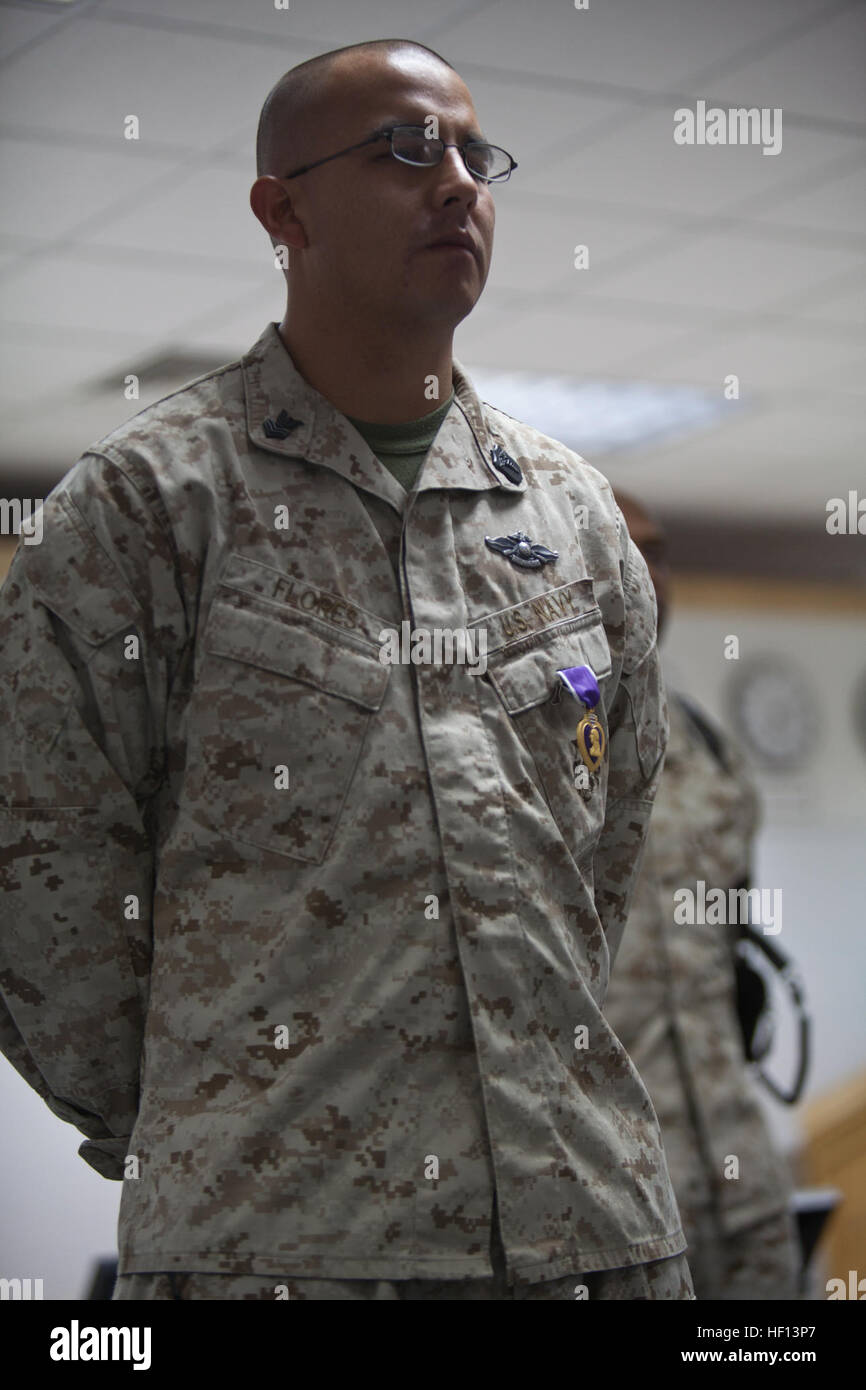 Petty Officer 1st Class Benny Flores stands before a crowd after ...