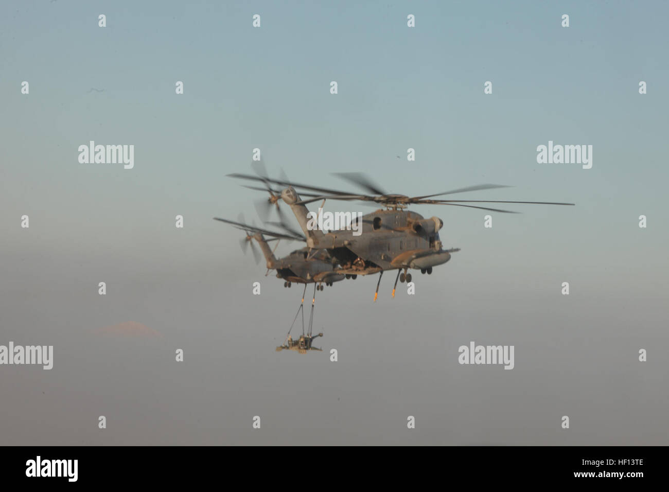 Two CH-53E Super Stallions from HMH-361 lift M777 howitzers over ...