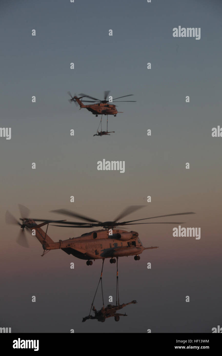 Two CH-53E Super Stallion helicopters from HMH-361 transport M777 155 ...