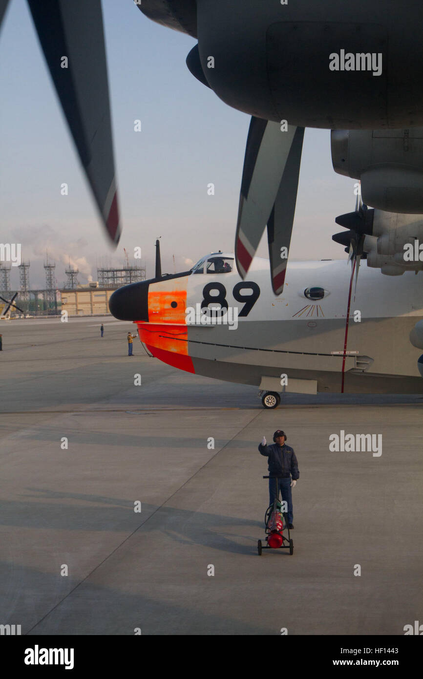 A Japanese Maritime Self Defense Force (JMSDF) service member signals ...