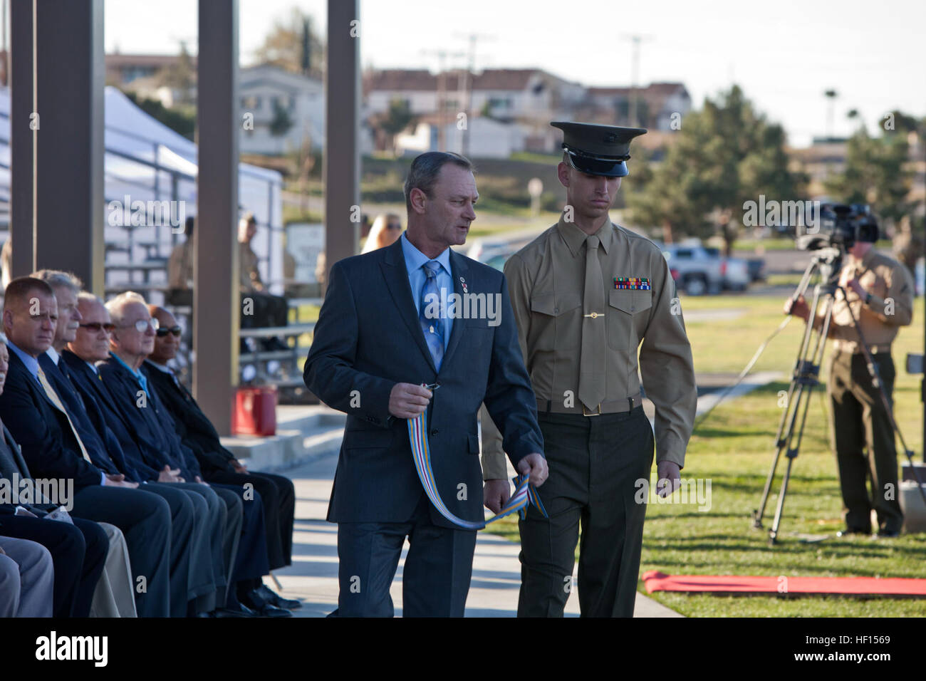 U.S. Marine Corps Master Gunnery Sgt. Bob Adwell (retired) carries the ...