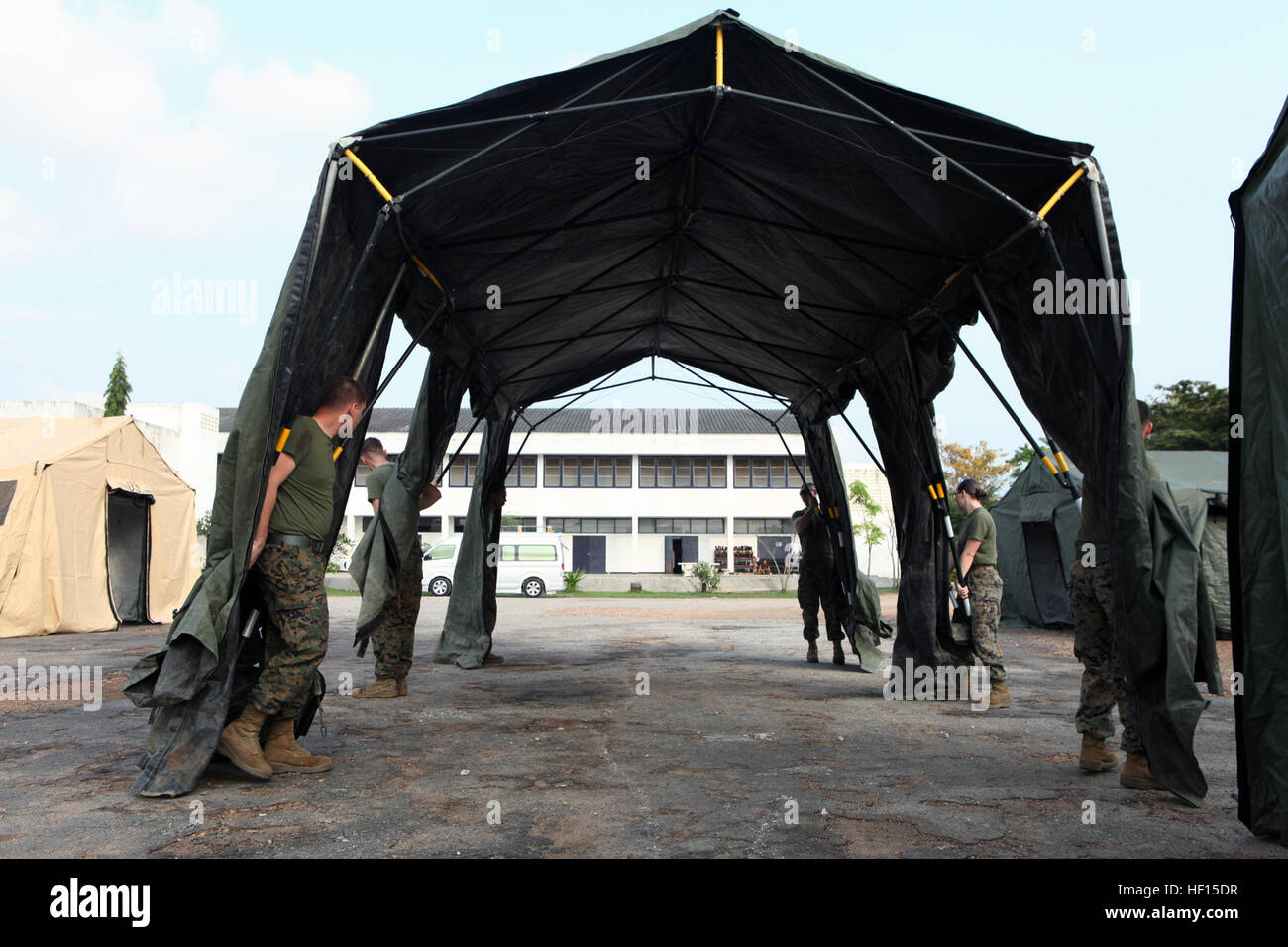 U.S. Marines from Combat Logistics Regiment 3 move tents into place as ...