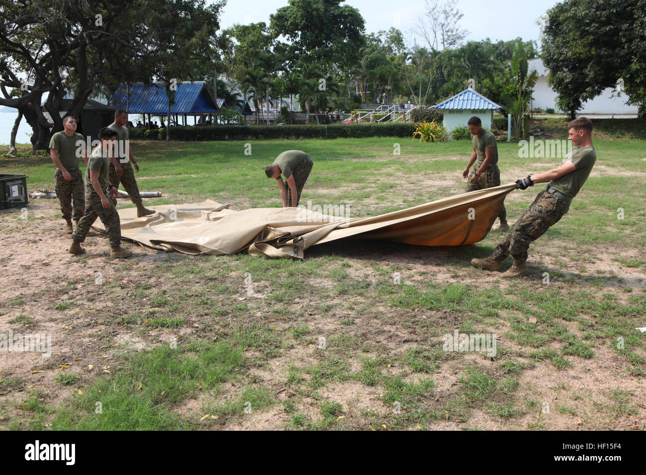 U.S. Marines with 3rd Marine Logistics Group prepare a water bladder ...
