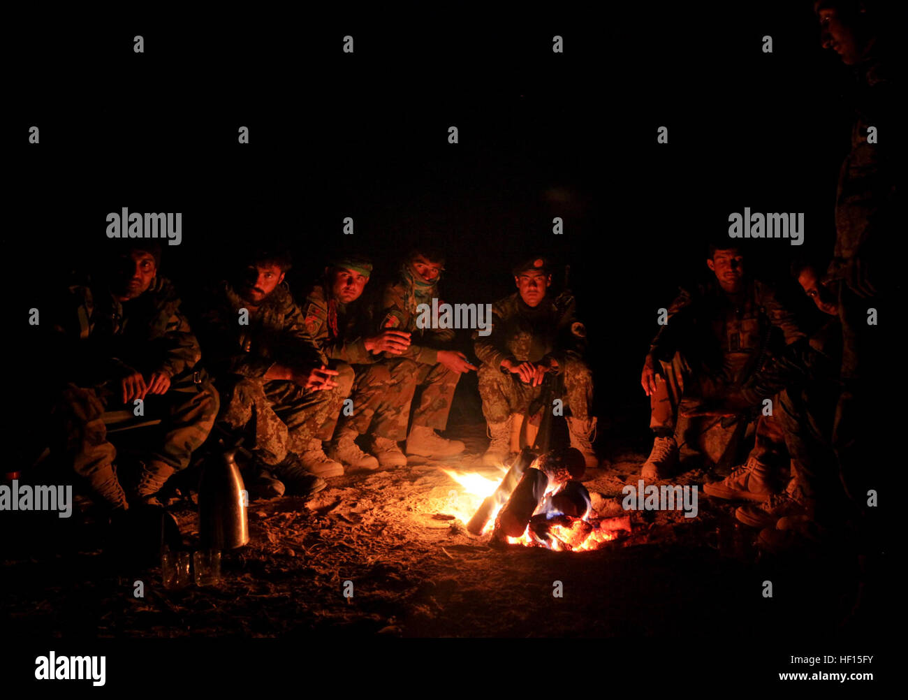 Afghan National Army soldiers keep warm beside a fire outside Combat ...