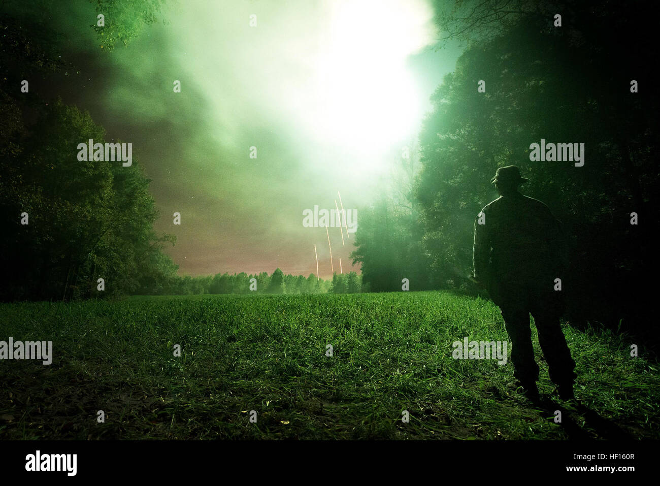An infantry instructor scans a field for enemies after firing a green ...