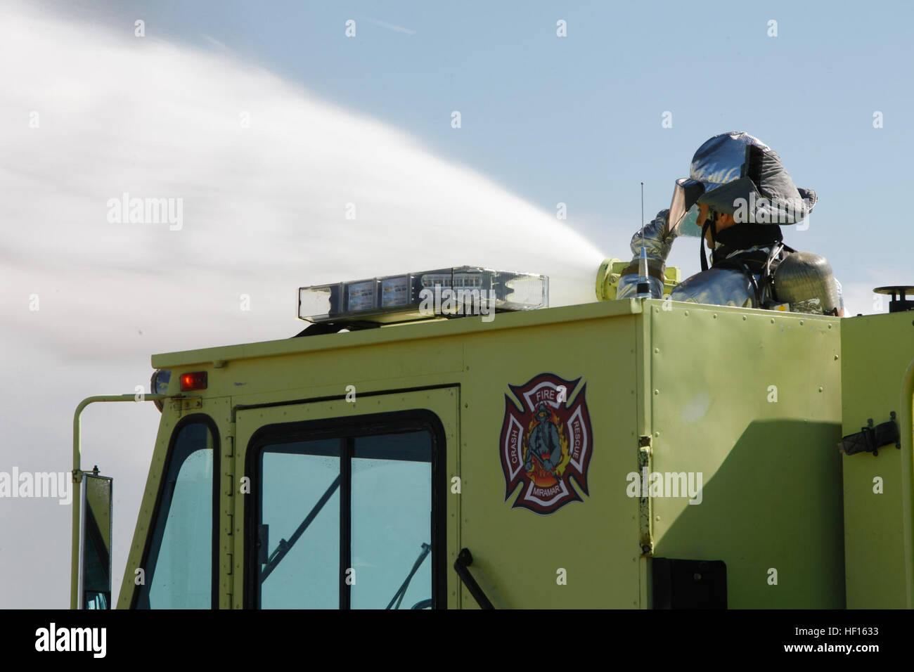 A Marine with Aircraft Rescue and Firefighting, here, sprays a water ...
