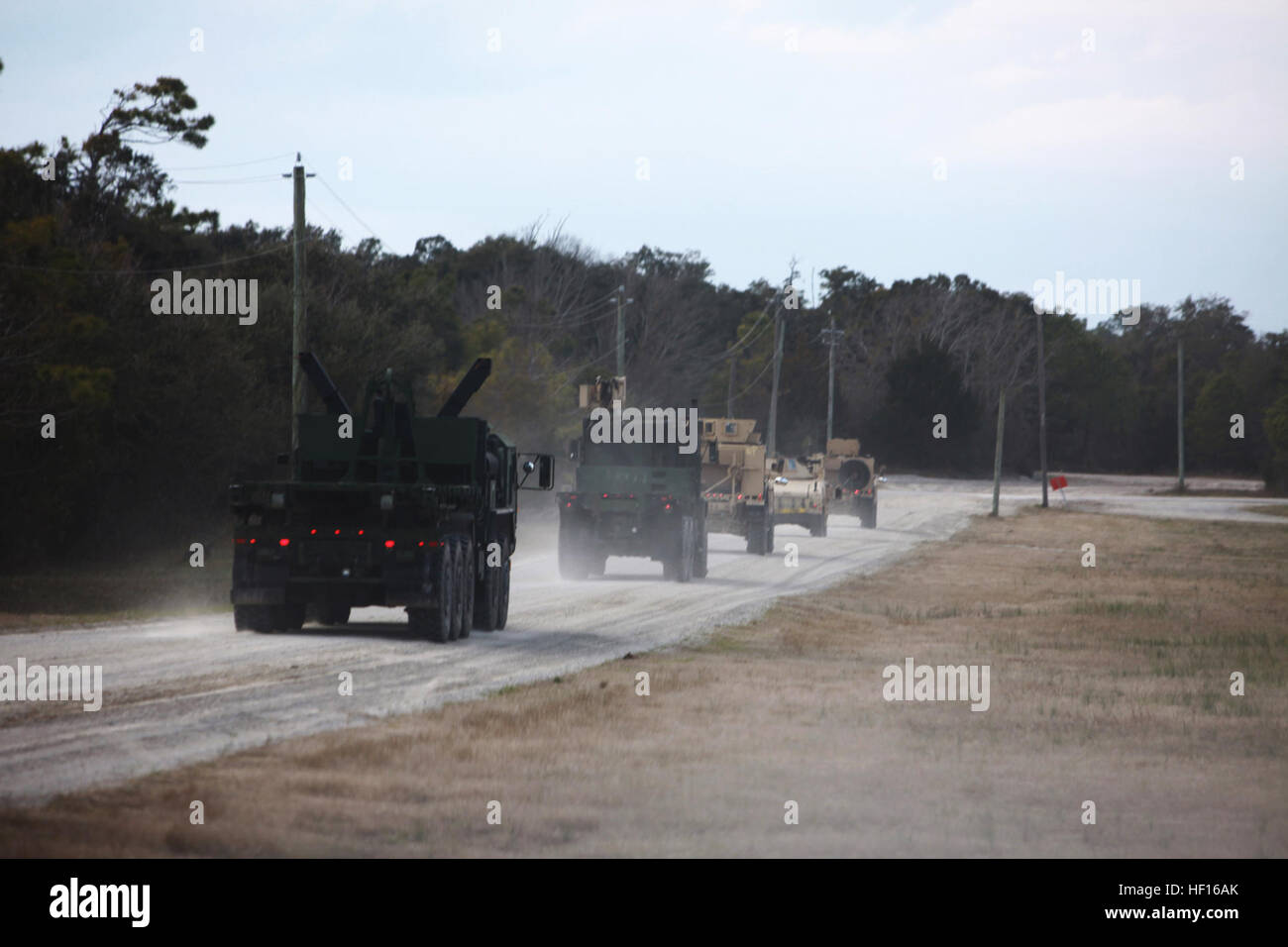 A convoy of vehicles departs a landing zone during a training exercise ...
