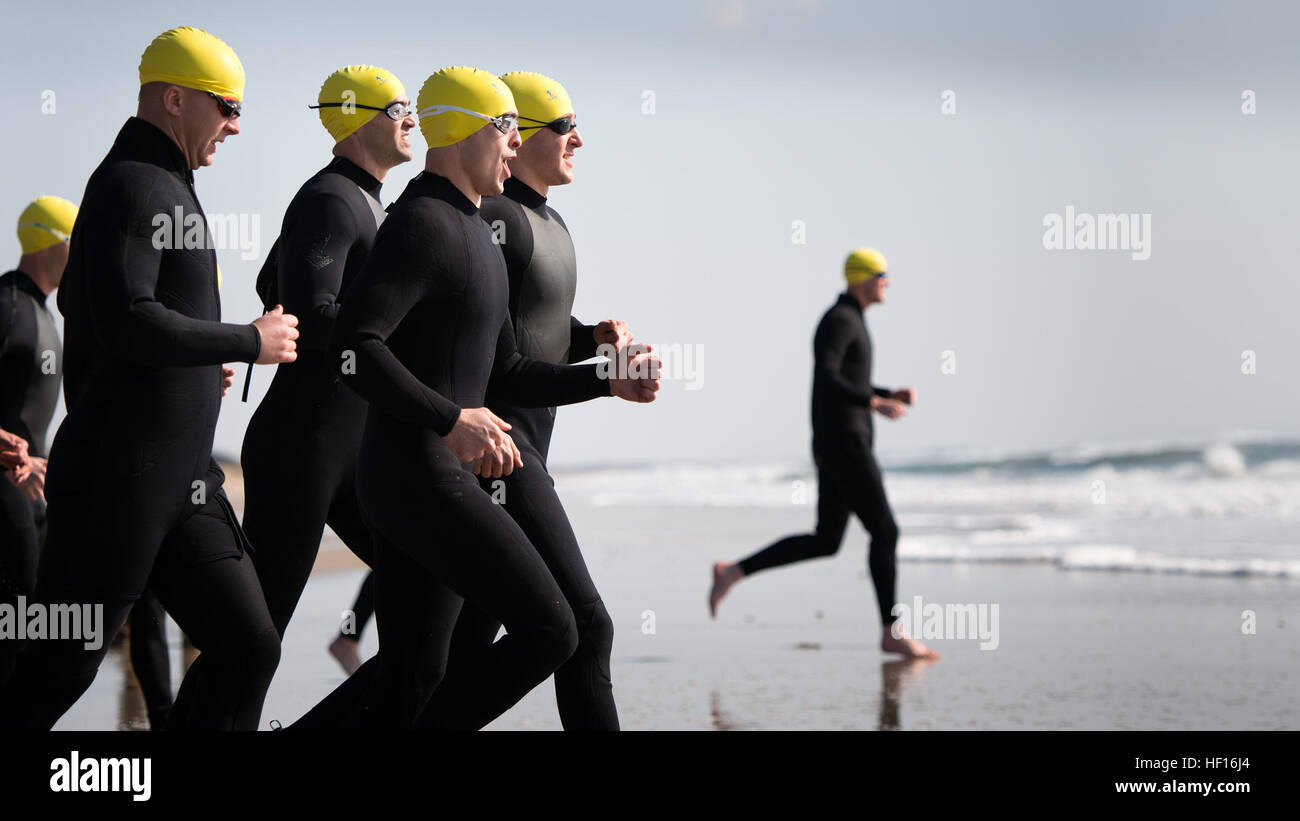 Marine students run into the ocean for a warm-up swim at Onslow Beach ...