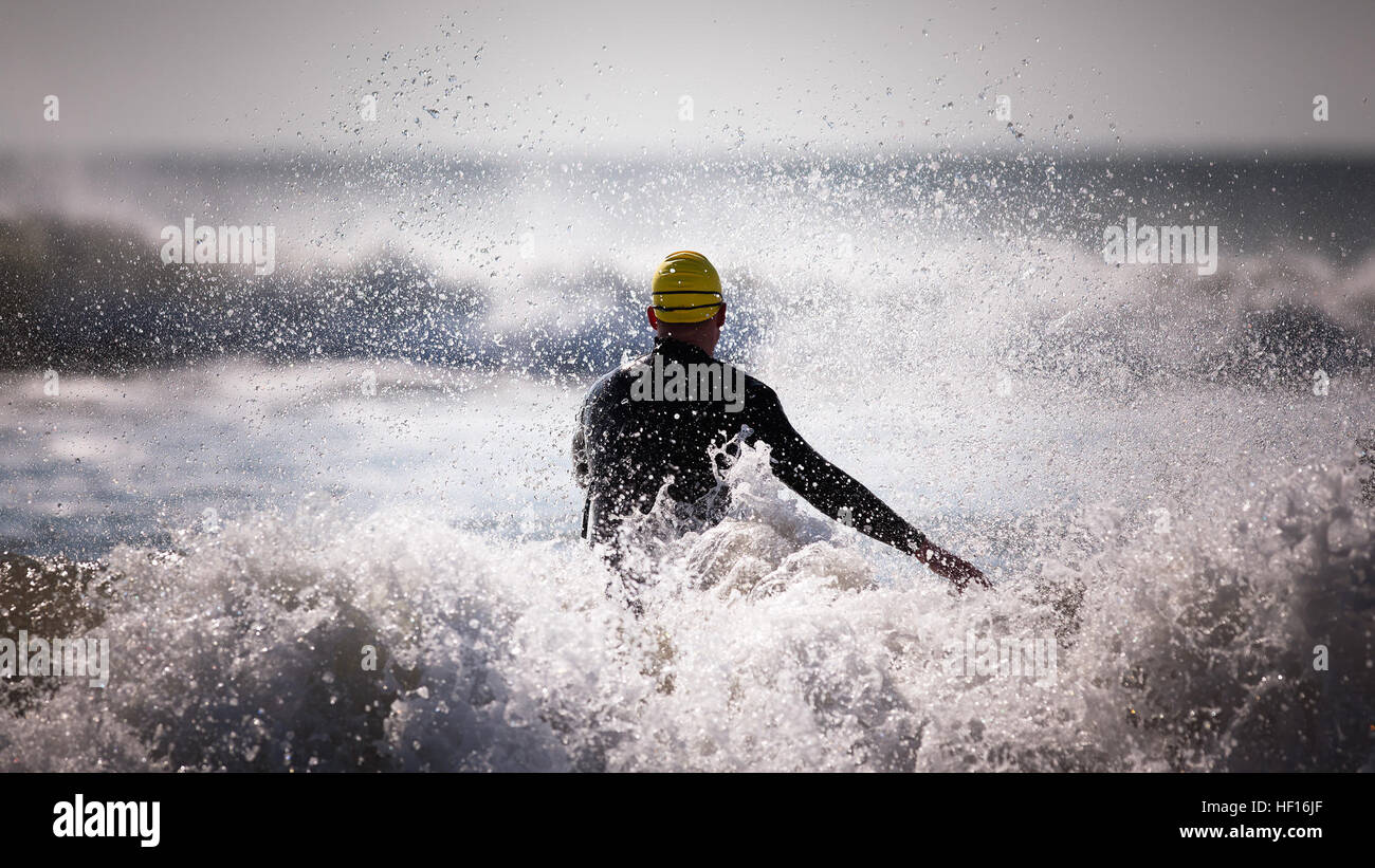 A Marine student heads into the ocean at Onslow Beach on Camp Lejeune ...
