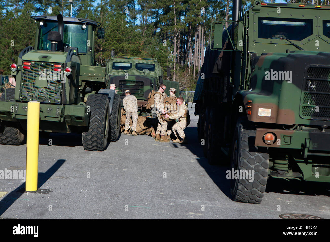 Marines with Marine Wing Support Squadron 271 pass bags down a line to ...