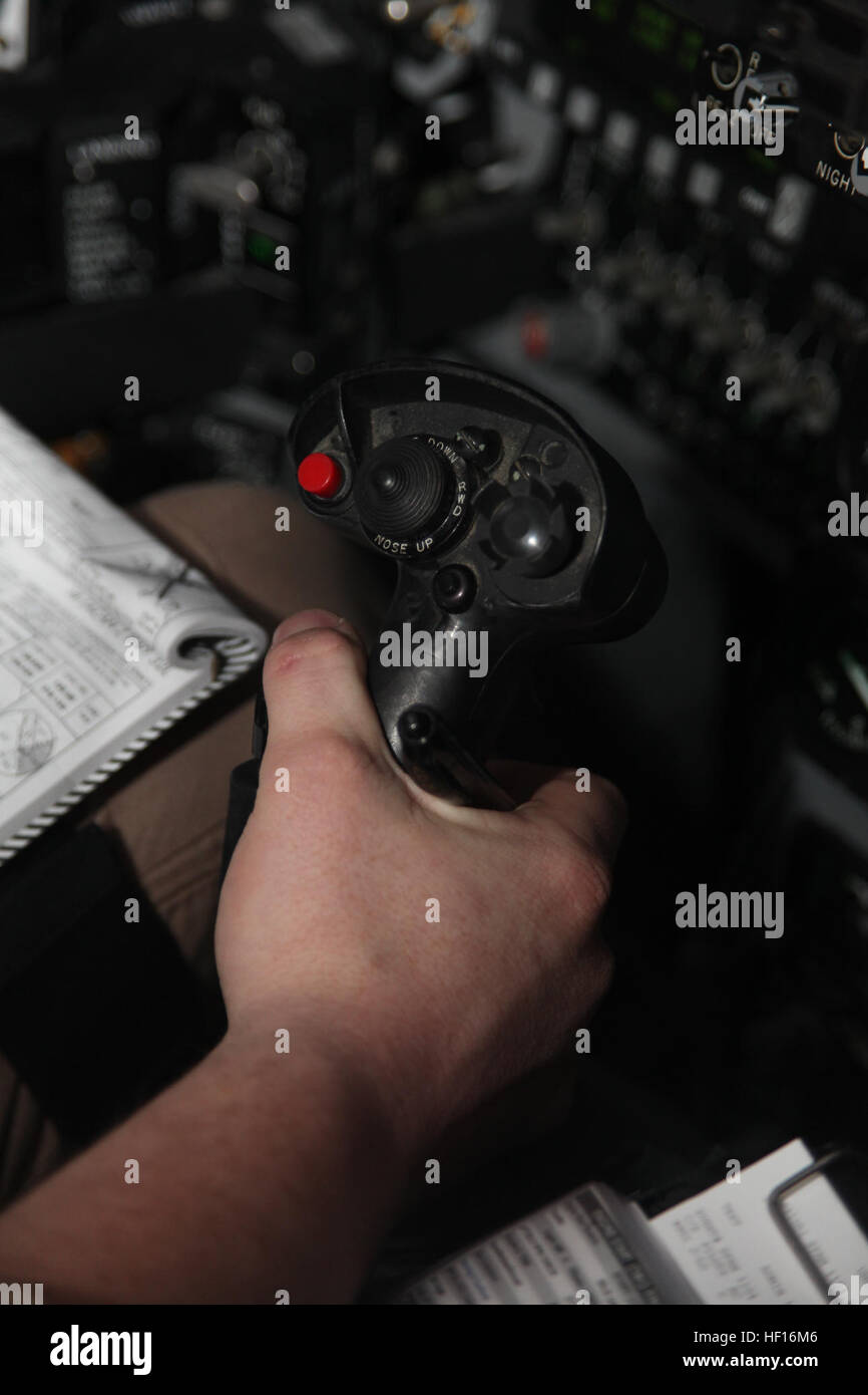 A pilot maneuvers the joystick while conducting a training flight in an ...