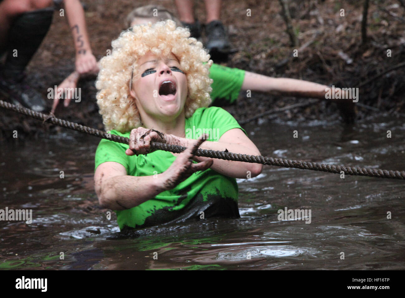 Vicki Robles, participant in the 5k mud run, swims through a lake of ...