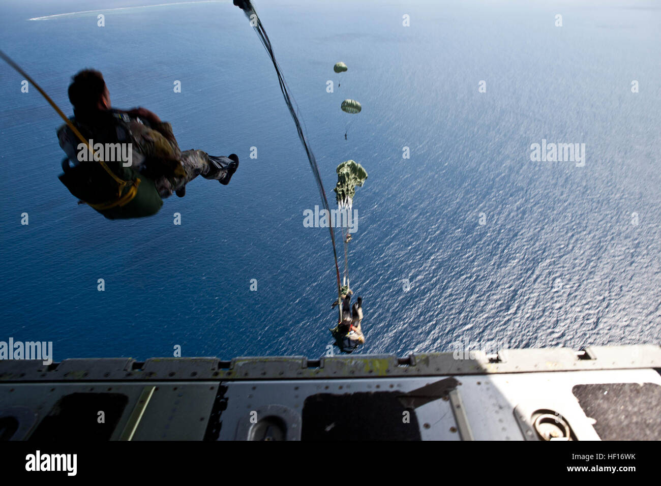 Soldiers execute static-line jumps out of a Marine-piloted KC-130J ...