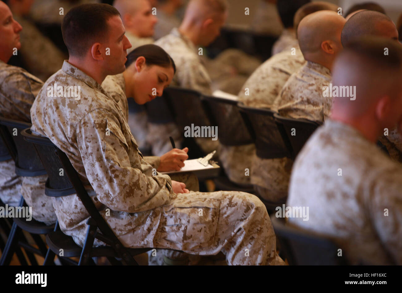 A Marine with 2nd Marine Logistics Group signs an attendance roster ...