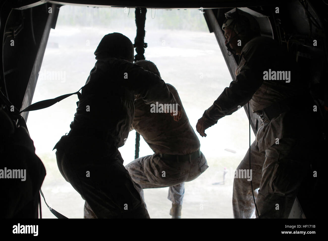 Marines with Special Operations Training Group gather a rope descending ...