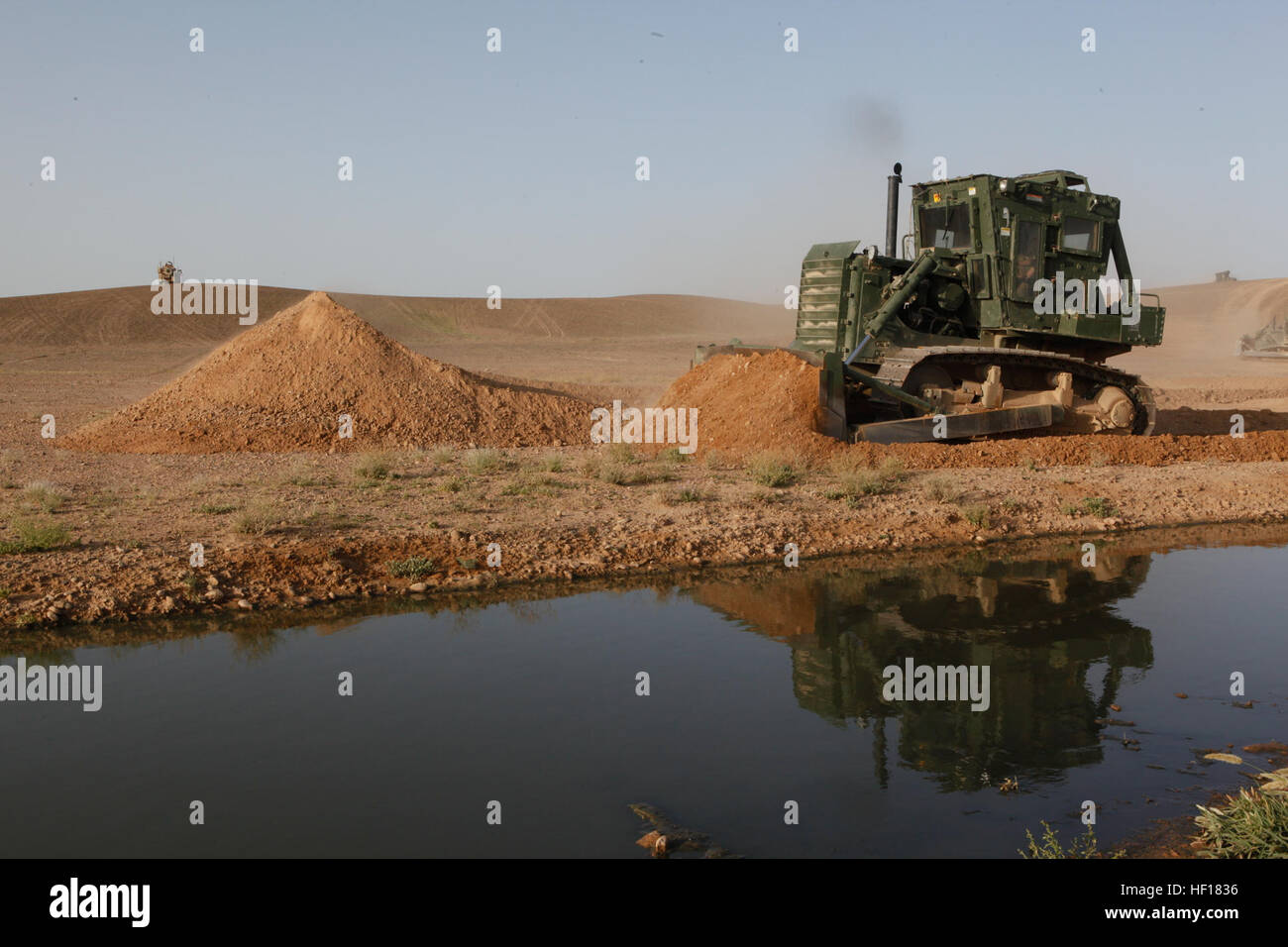 U.S. Navy Equipment Operator Third Class John Harmon, a heavy equipment ...