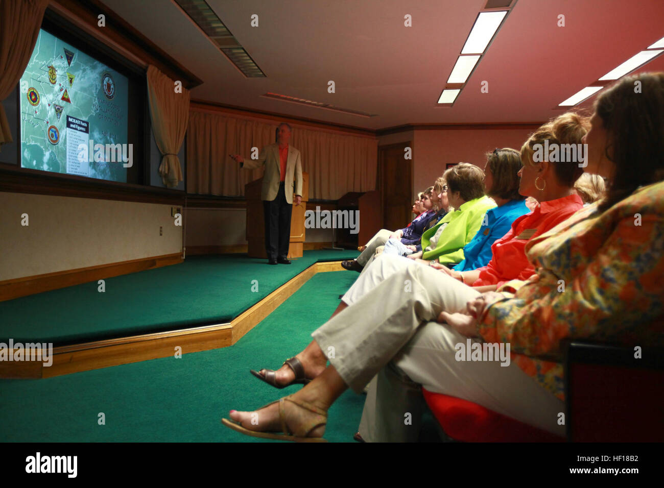 School district representatives pay attention to a slideshow given by ...