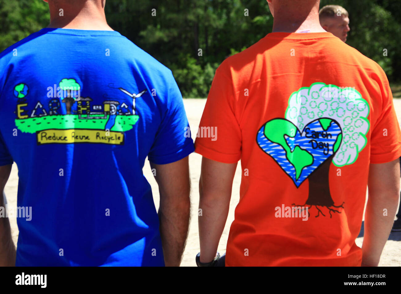 Two volunteers for the Splash for Trash event show off their Earth Day ...