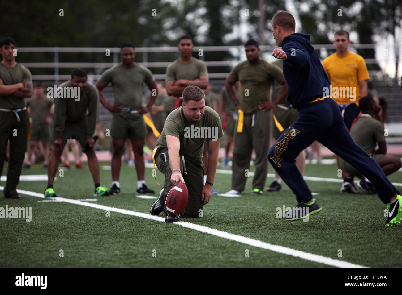 A Sailor with 2nd Marine Logistics Group kicks a football during a ...