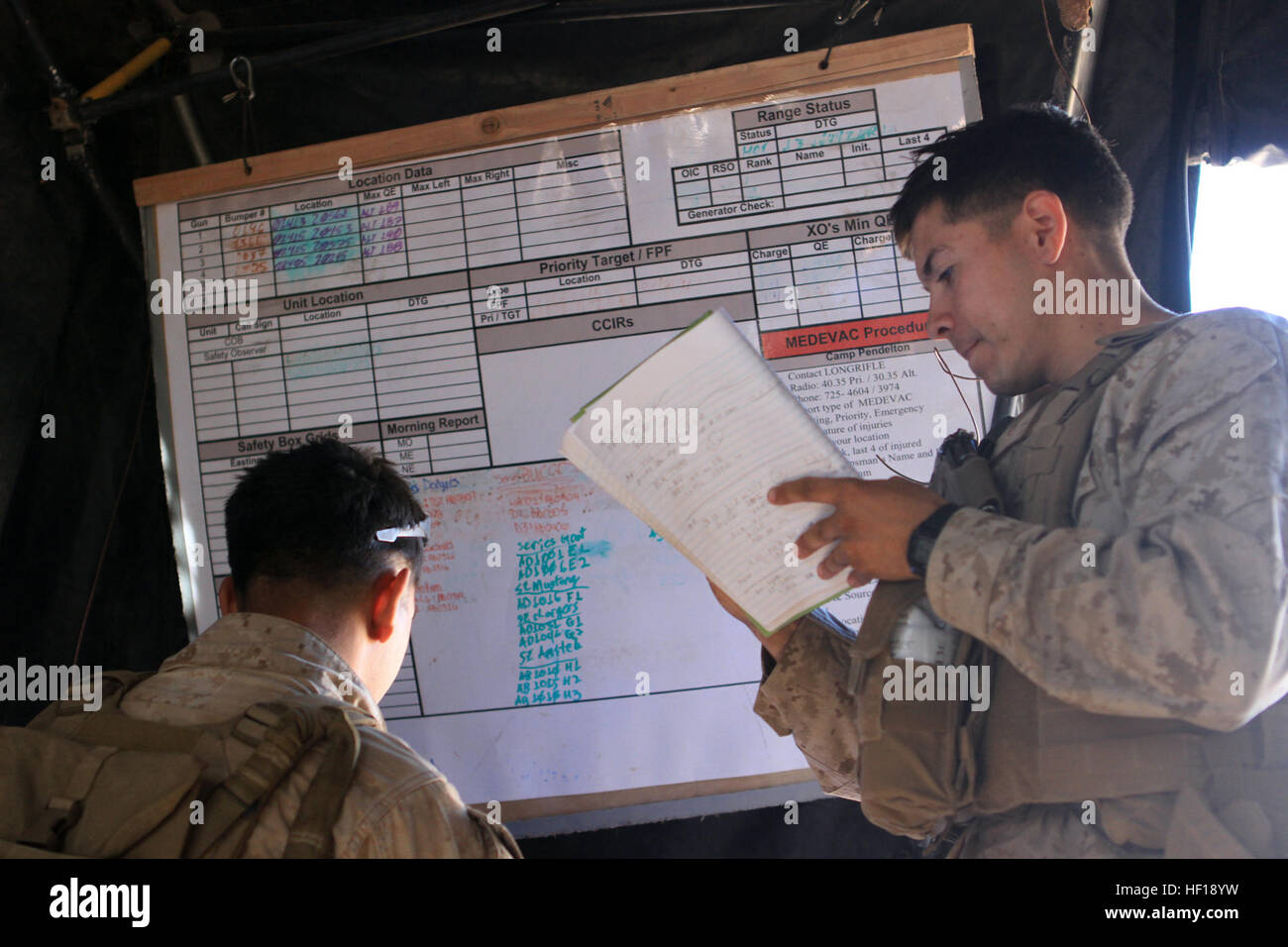 Second Lt. Pascual Eley (right), a fire directions officer serving with ...