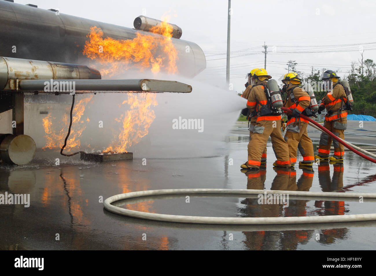 Firefighters battle a fire during a mobile aircraft fire training ...