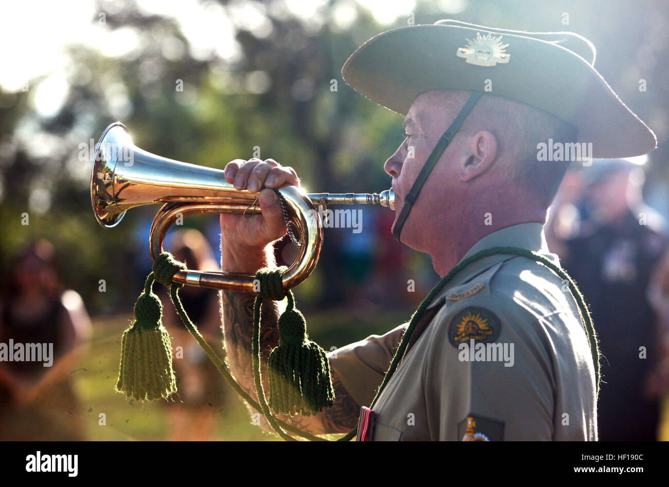 An Australian Army bugler sounds "Last Post," at the USS Peary monument ...