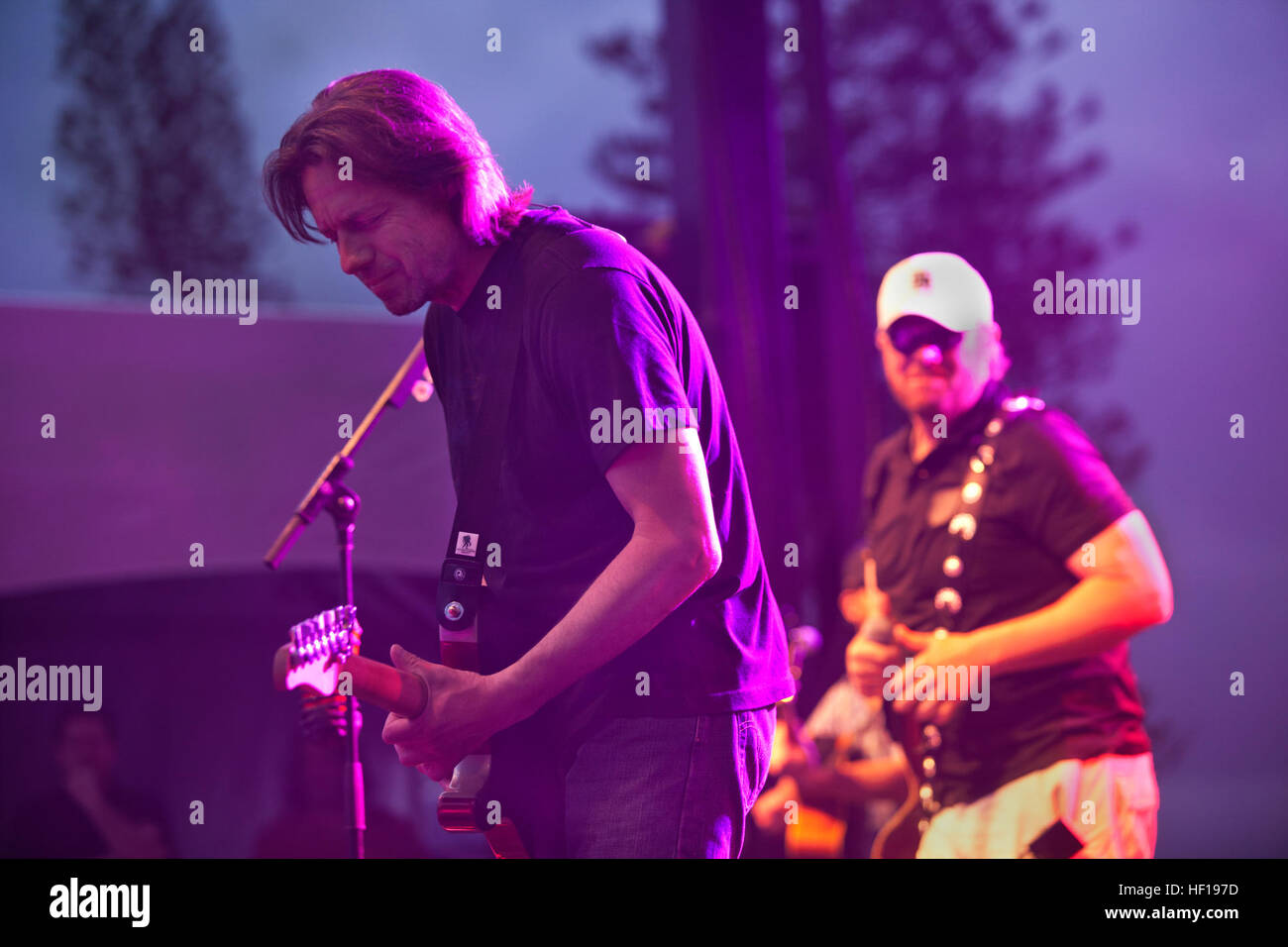 The lead guitar player goes to front stage during a concert for Marine ...