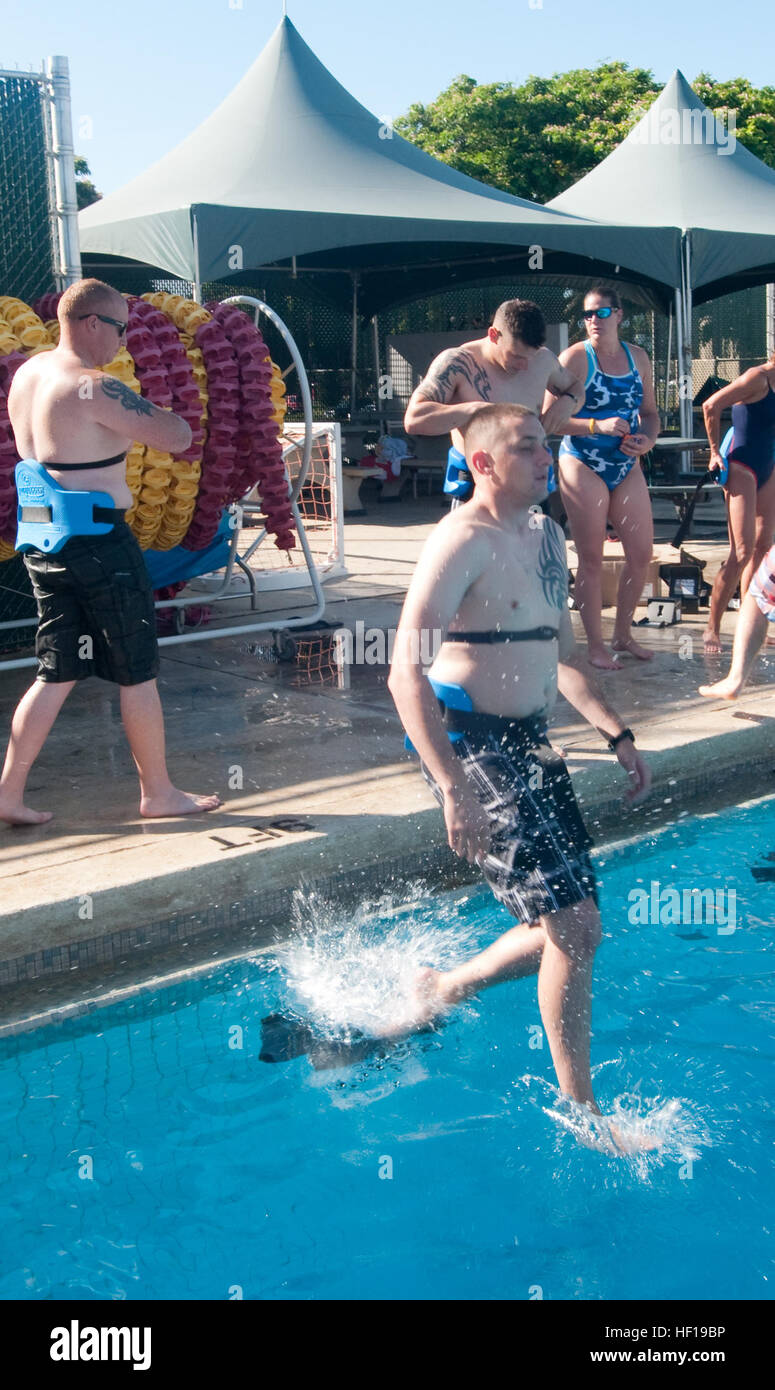 Marines attach flotation devices and dive into the pool for deep water ...