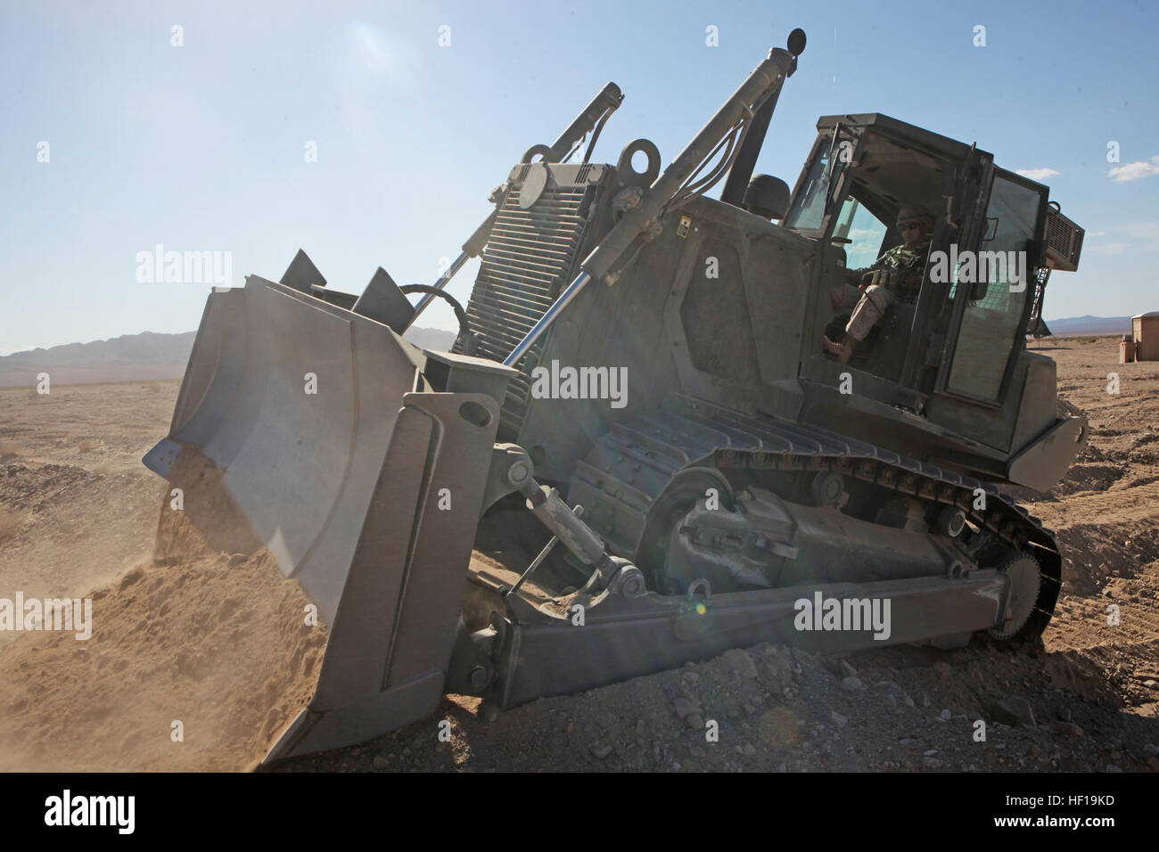 A bulldozer levels a berm at a forward operating base at Twentynine ...