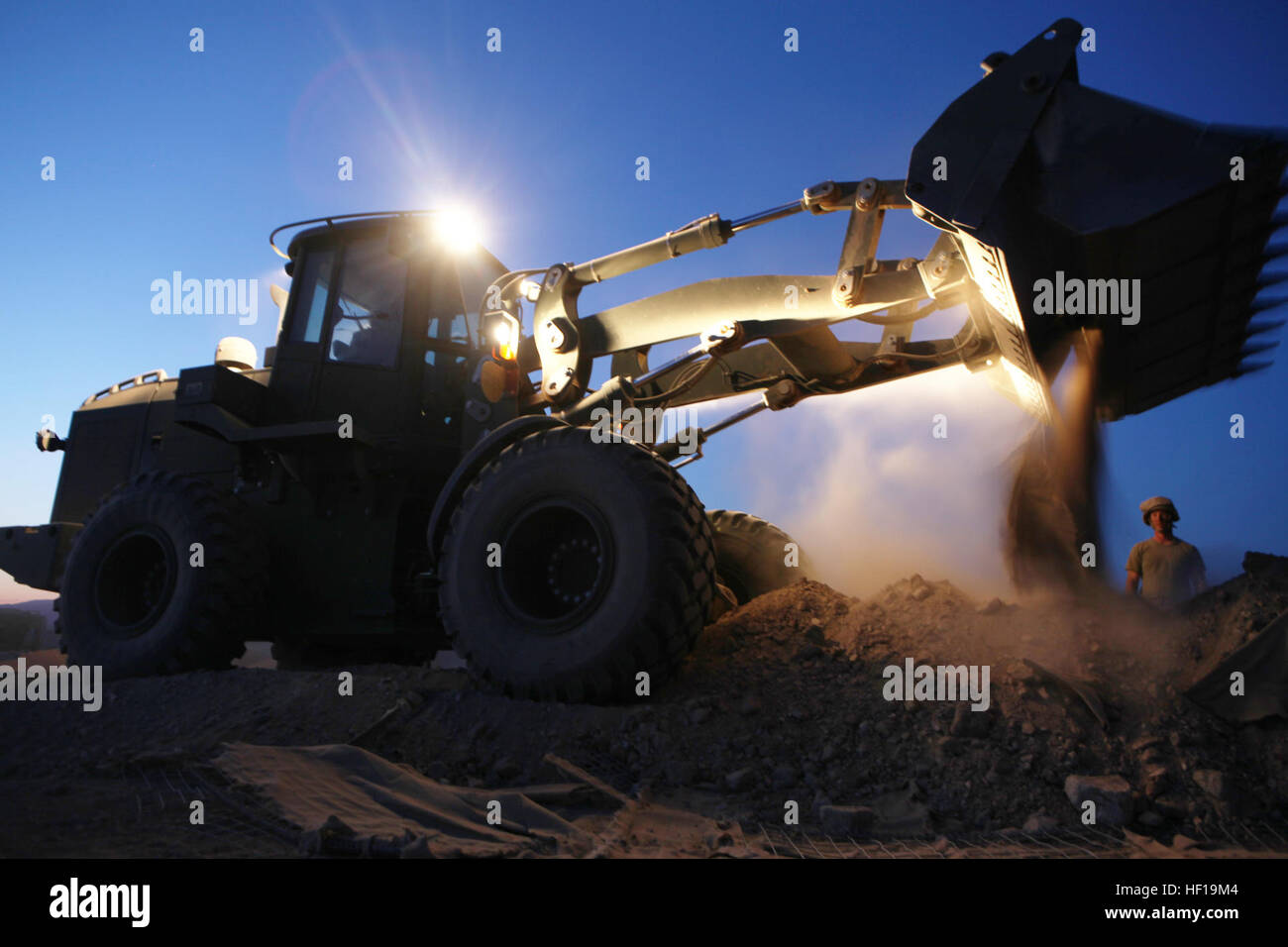 A TRAM demolishes an earthen barrier during a deconstruction project ...
