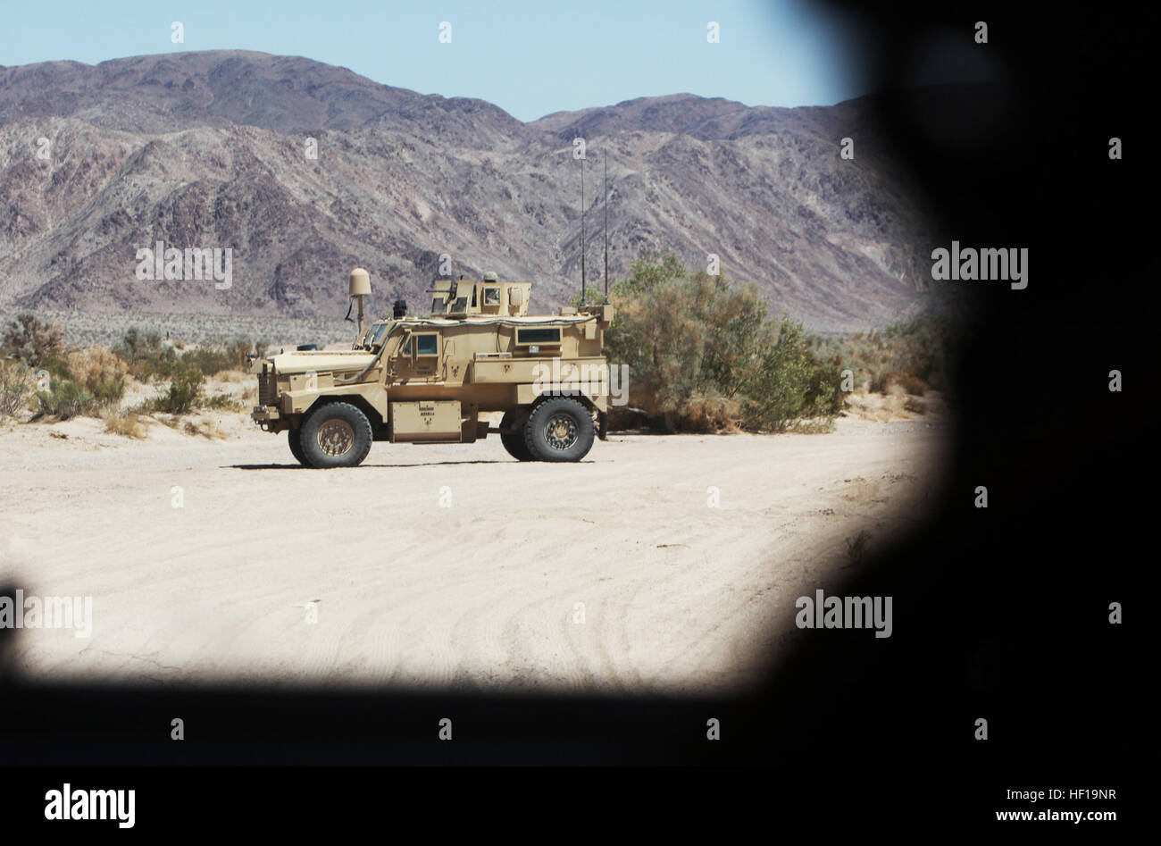 A Mine Resistant Ambush Protected vehicle passes in front of another ...