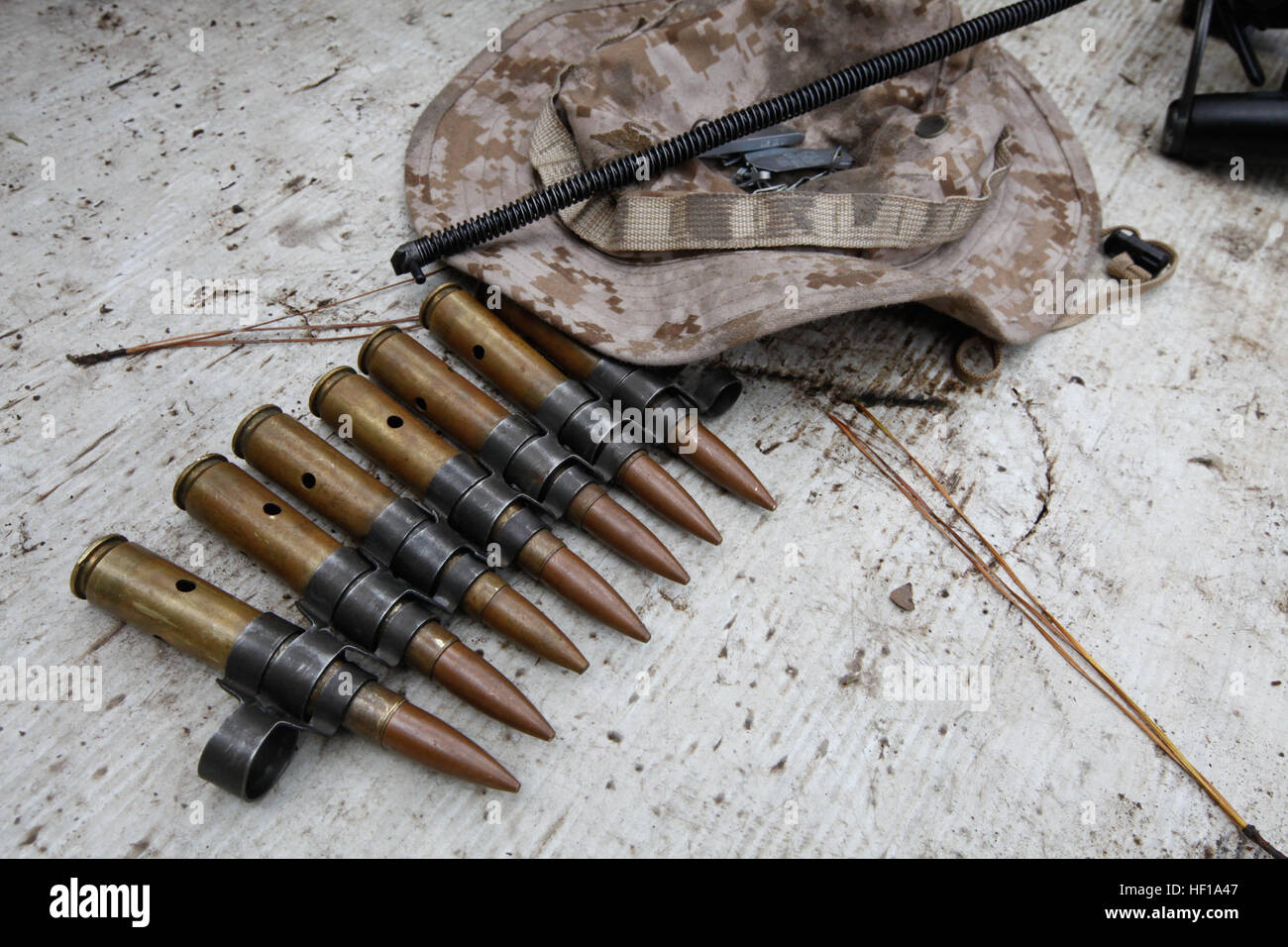 Ammo for an M2 .50-caliber machine gun rests on the ground during the ...