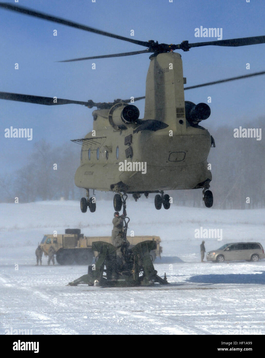A soldier of the 1st Battalion,119th Field Artillery Regiment, attaches ...
