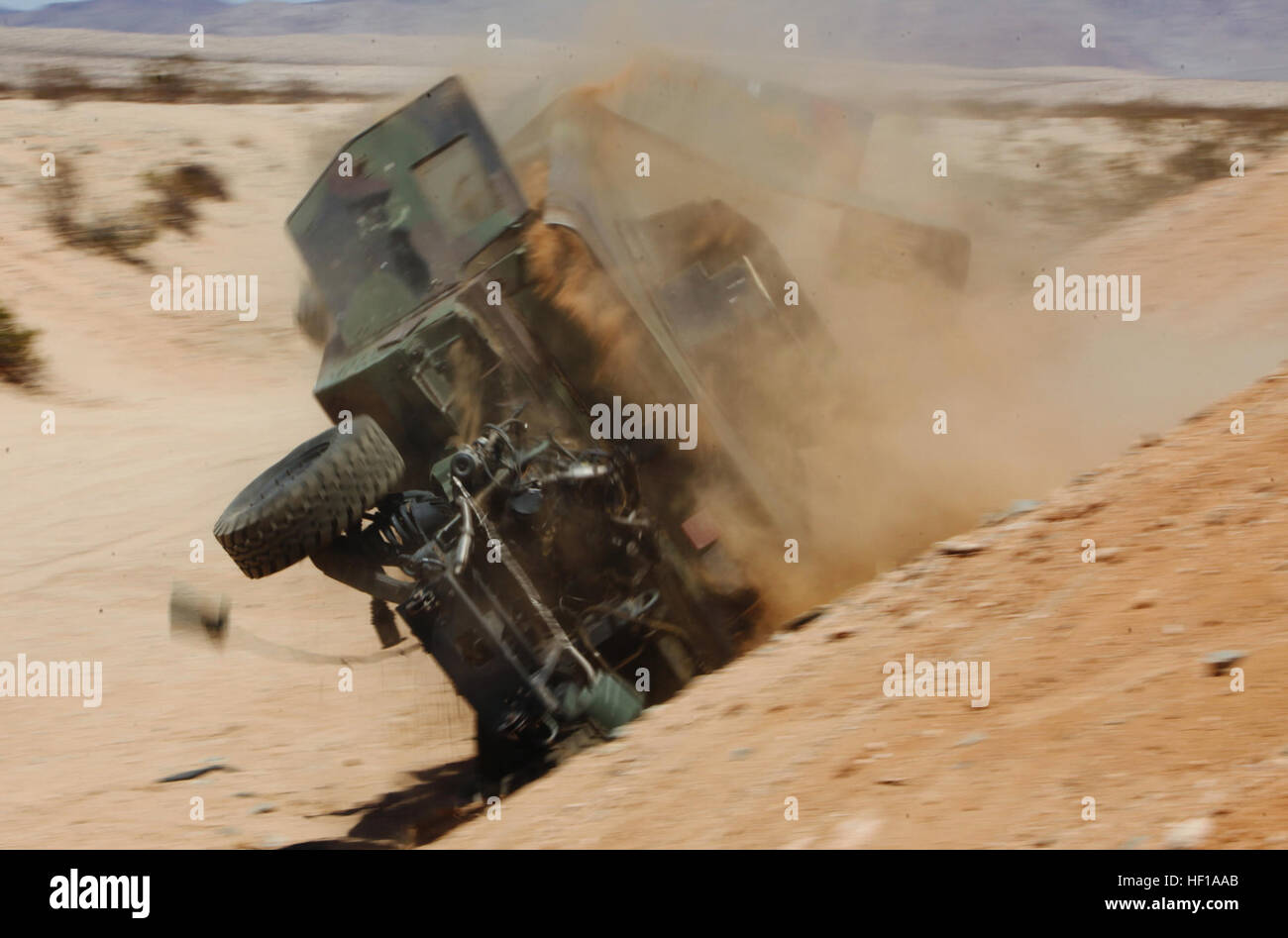 An obsolete Humvee tumbles into a ravine during a training exercise ...