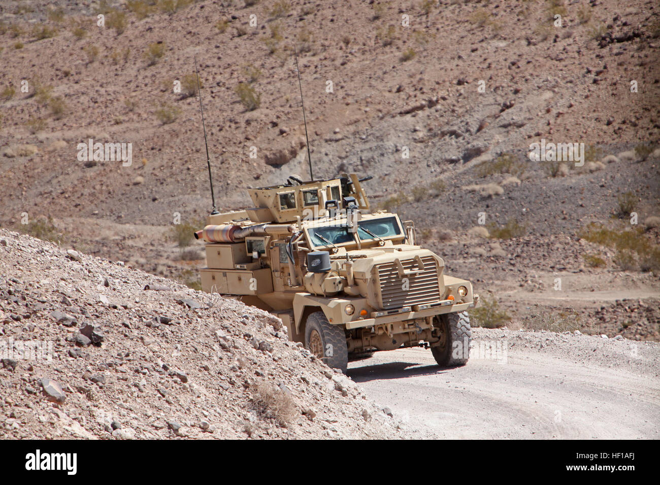 A Mine Resistant Ambush Protected Vehicle turns around a rocky berm ...