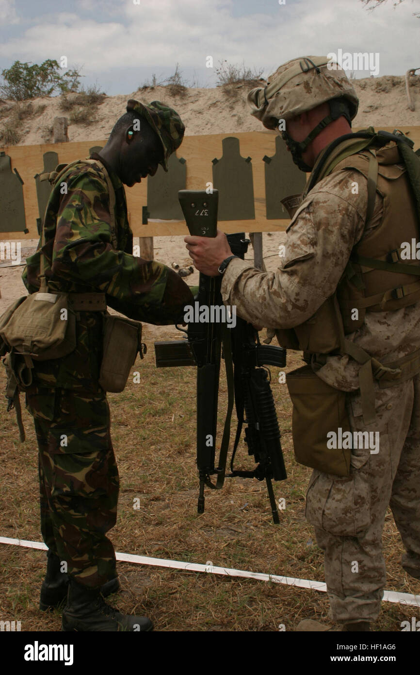 U.S. Marine Corps Sgt. Edward W. Deptola exchanges his M16A4 rifle for ...