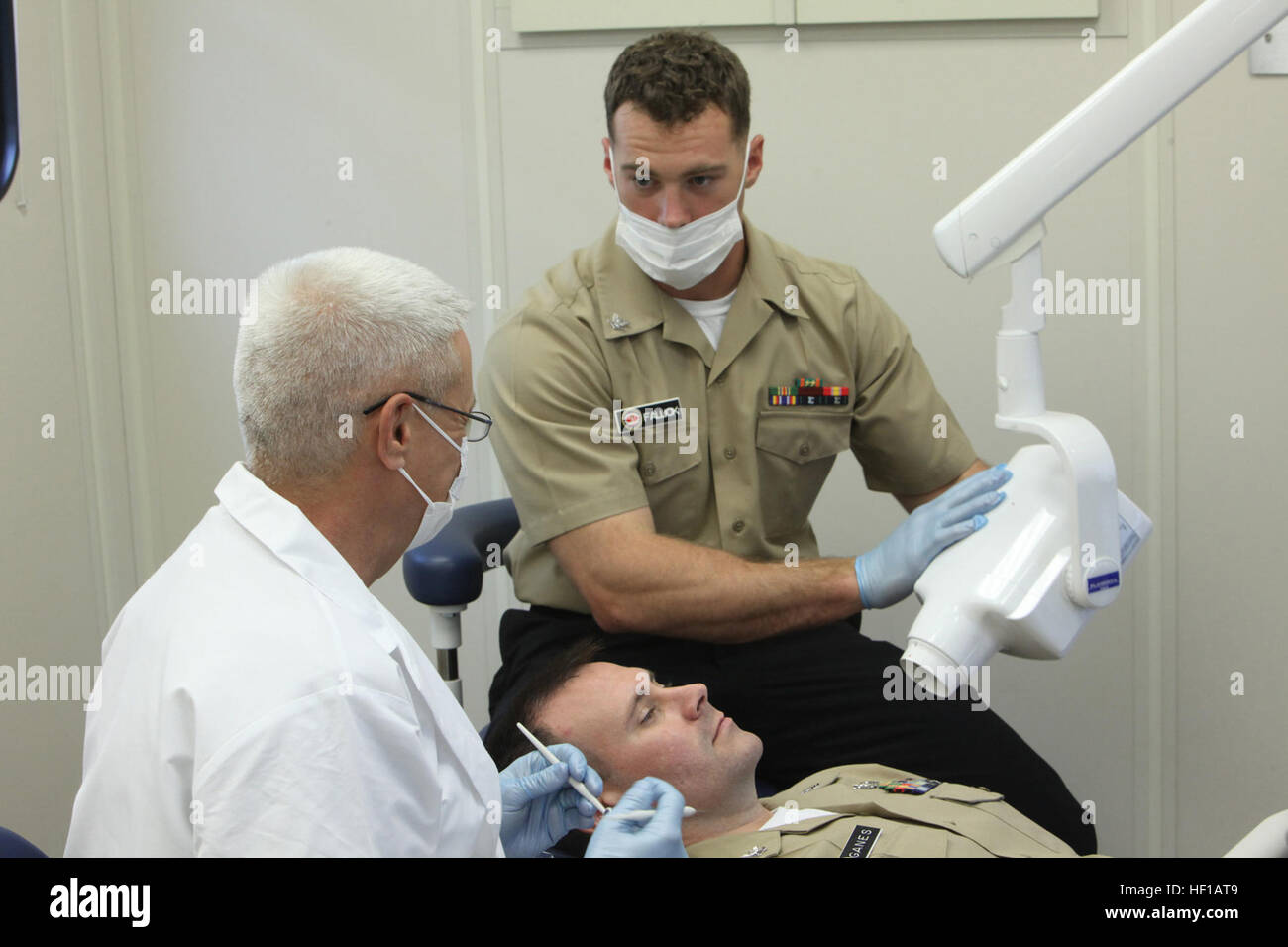 Petty Officer 3rd Class Joshua J. Fallick, right, a mobile dental unit ...