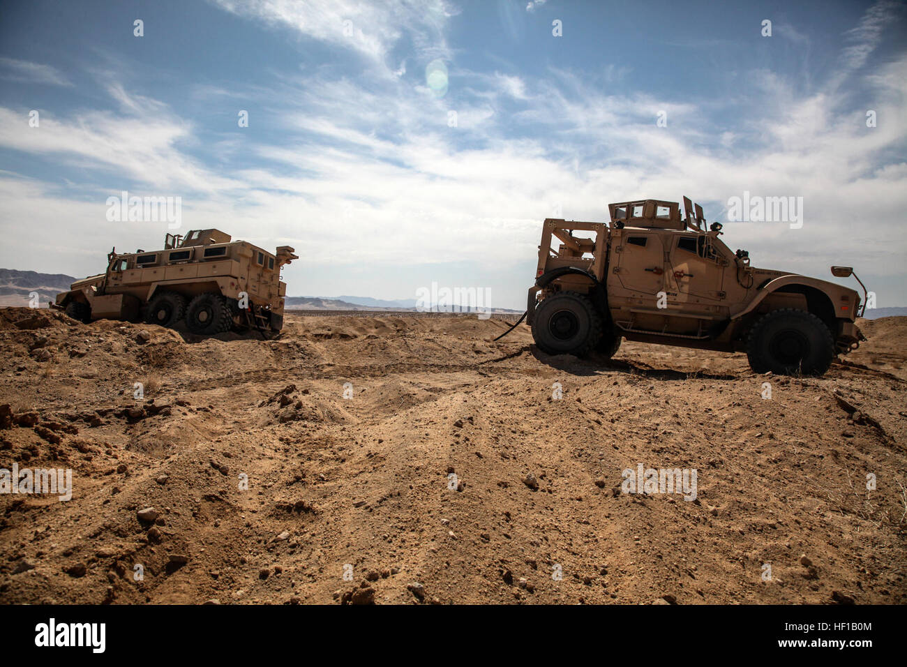 A Mine Resistant, Ambush Protected (MRAP) All Terrain Vehicle tows ...