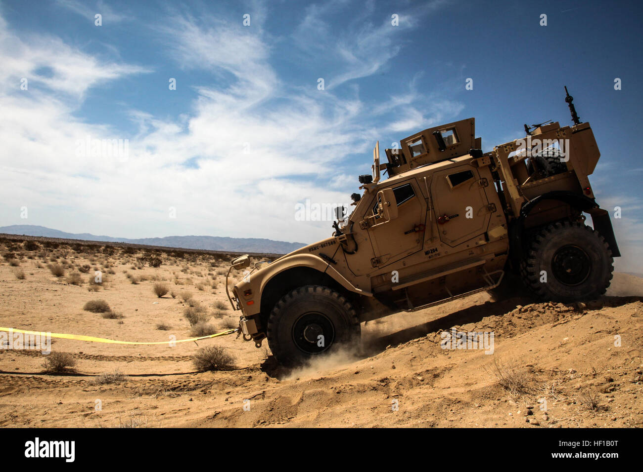 A Mine Resistant, Ambush Protected (MRAP) All Terrain Vehicle tows ...
