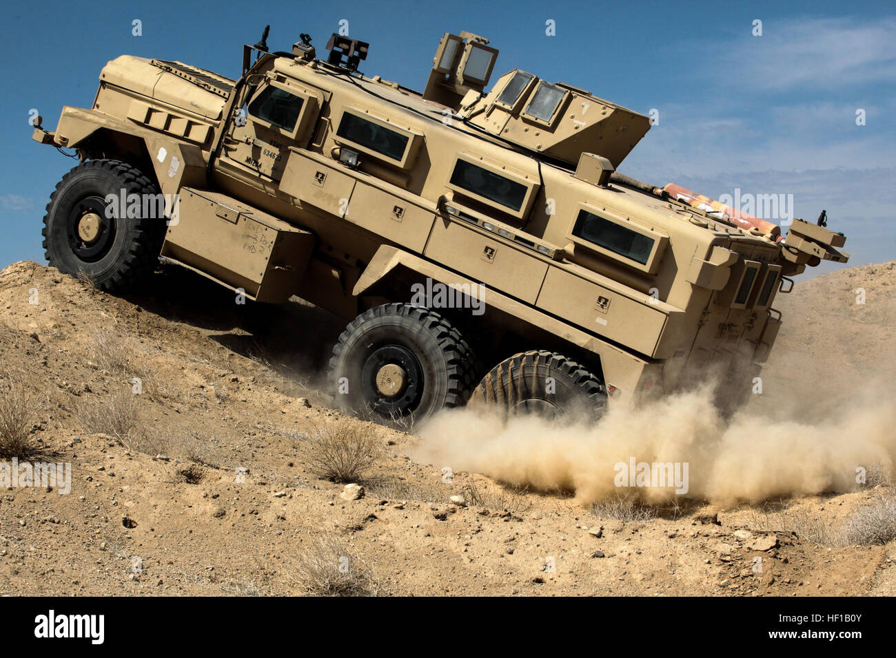 A Mine Resistant, Ambush Protected (MRAP) vehicle is entrenched in the sand during a recovery ...