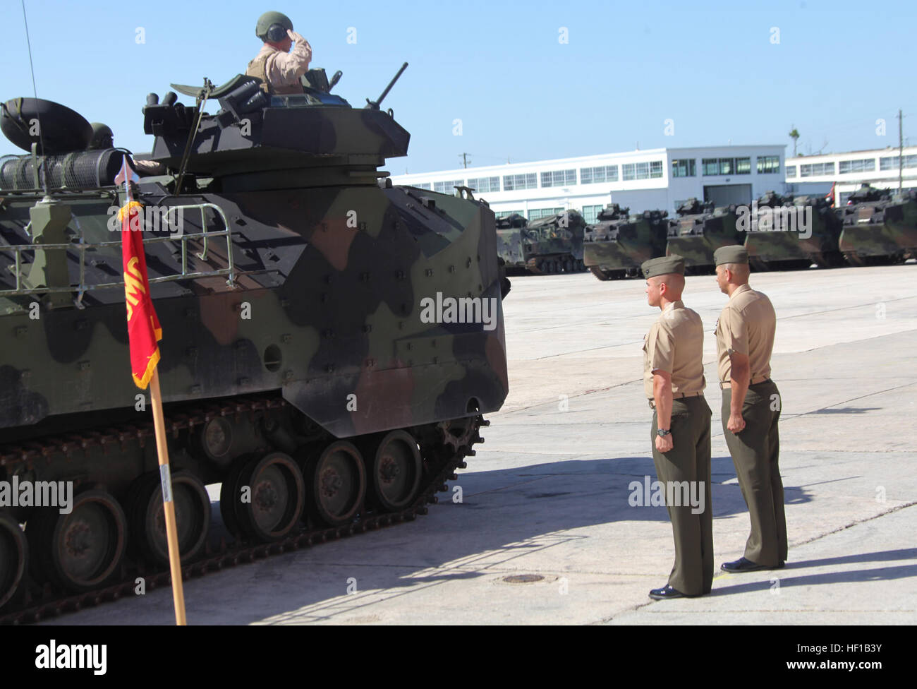 A Marine in an amphibious assault vehicle salutes Lt. Col. Patrick W ...